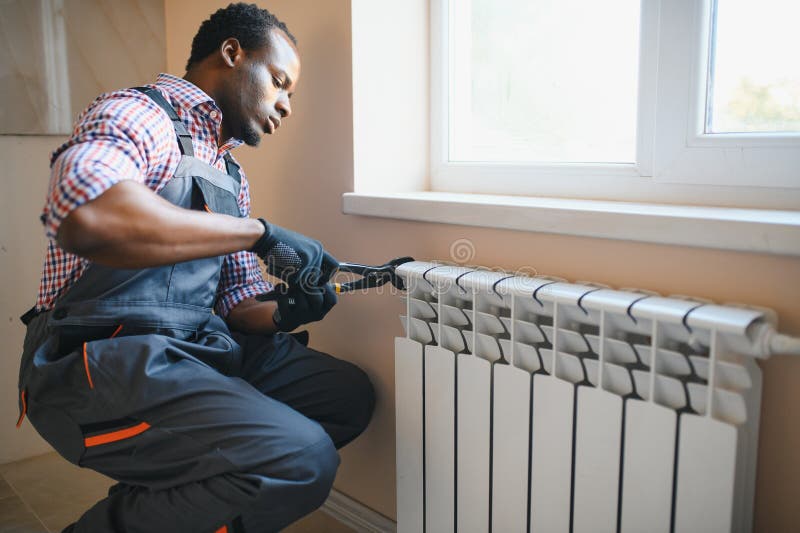 Afro Repairman in Blue Using Tools while Installing or Repairing ...