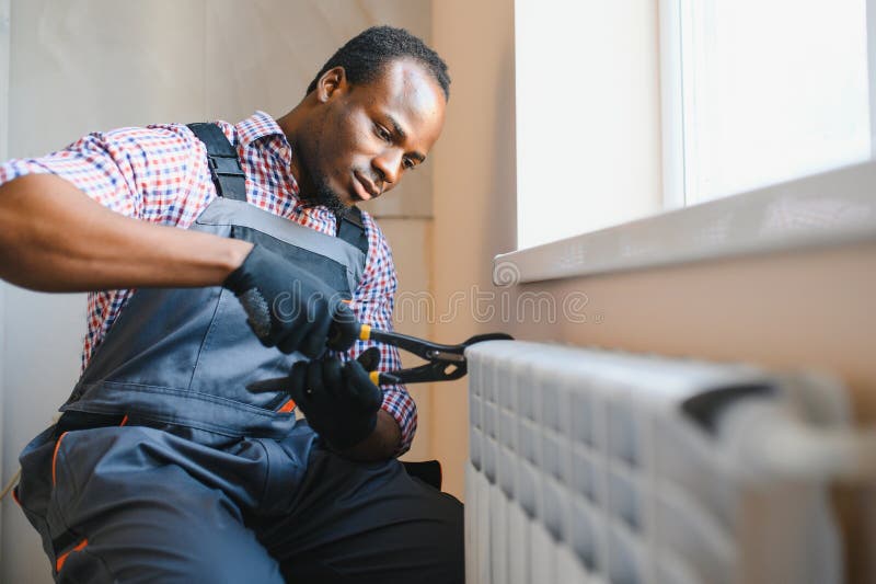 Afro Repairman in Blue Using Tools while Installing or Repairing ...