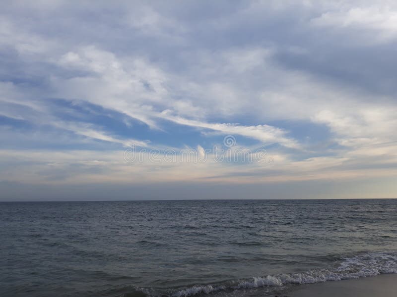 Afternoon Beach with a Reddish Cloud Swirl Stock Image - Image of ...