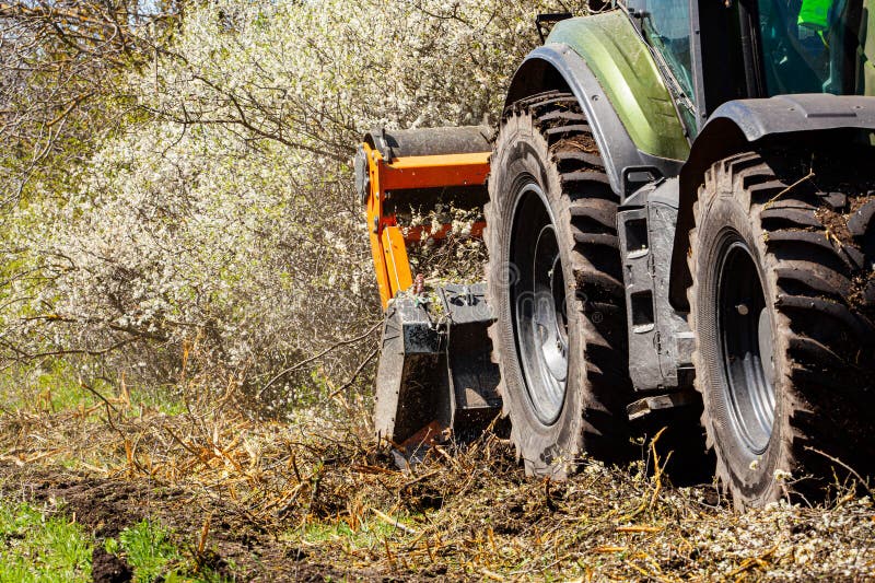 Against a Background of Nature, a Tractor-type Machine is Captured ...