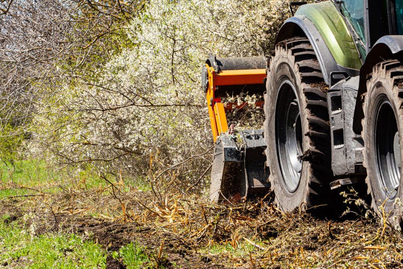 Against a Background of Nature, a Tractor-type Machine is Captured ...