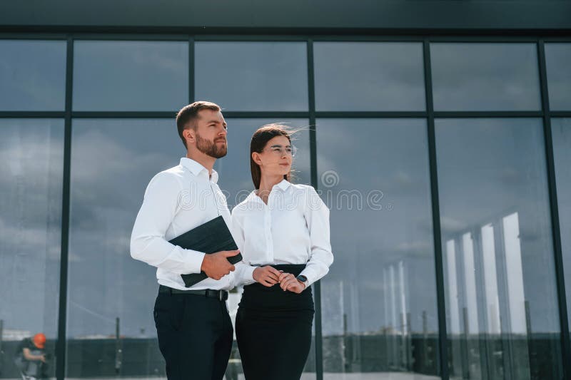Against Big Windows. Man with Woman are Working on the Construction ...