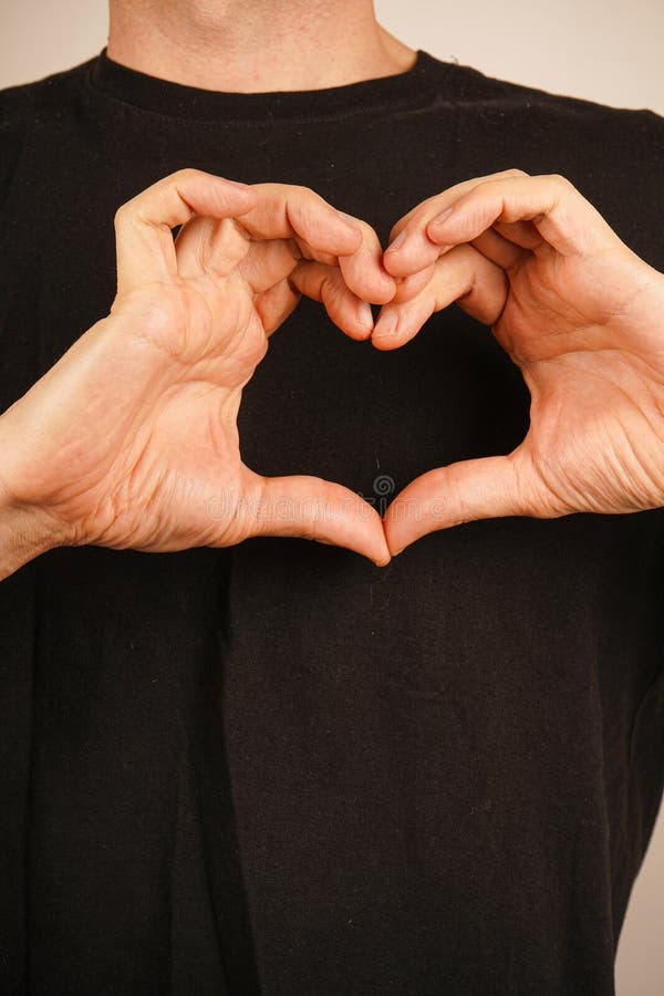 Against a Bright Plain Wall, Two Hands Create a Heart Shape. this ...