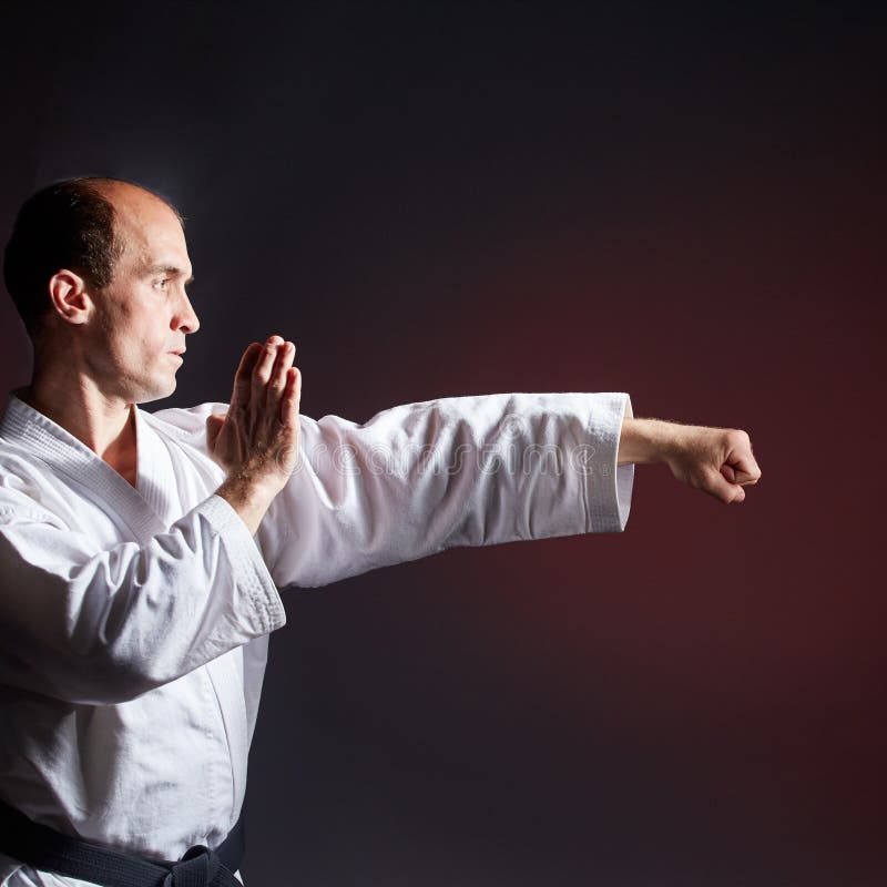 Against a Dark Red Background, a Young Athlete Makes a Punch Arm Stock ...