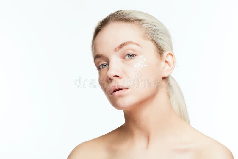 Age Protection. Young Woman with Drops of Face Cream on Face Stock ...