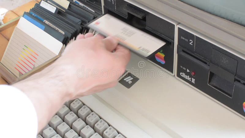 Aged Apple Computer and Hand Insert Floppy Inside Then Typing on ...