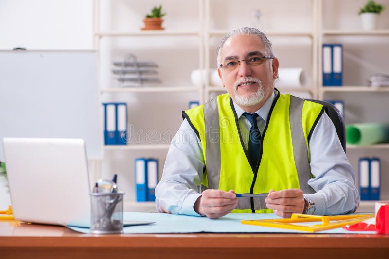 The Aged Construction Engineer Working in the Office Stock Photo ...