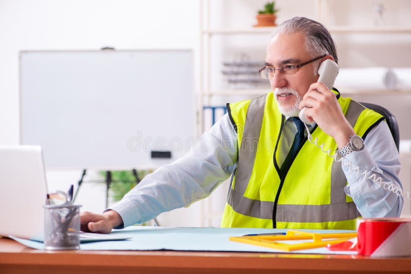 The Aged Construction Engineer Working in the Office Stock Photo ...