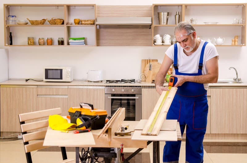 Aged Contractor Repairman Working in the Kitchen Stock Image - Image of ...