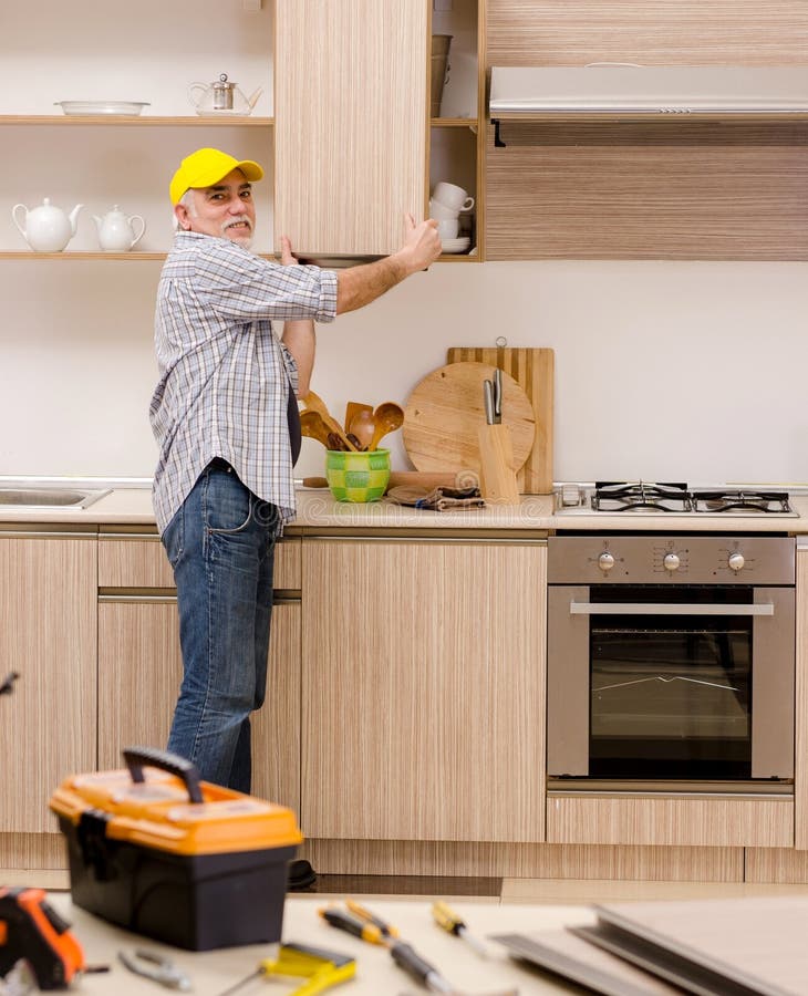 Aged Contractor Repairman Working in the Kitchen Stock Photo - Image of ...