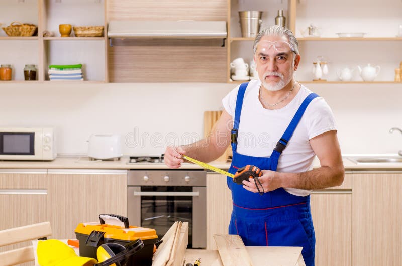 Aged Contractor Repairman Working in the Kitchen Stock Photo - Image of ...