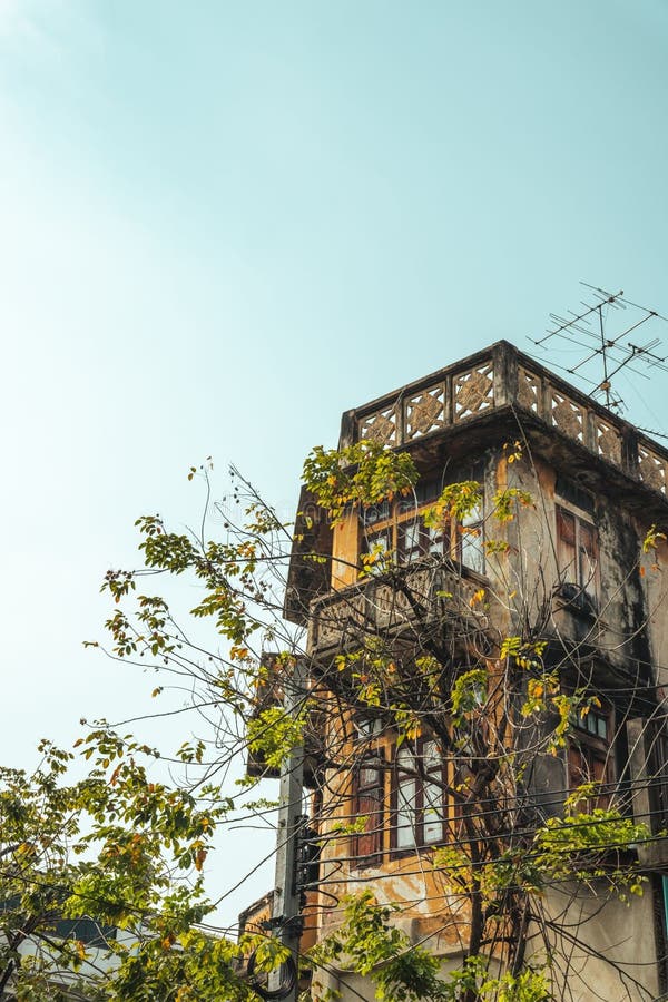 Aged, Corroded Building Situated Against a Vivid Blue Sky with the Sun ...