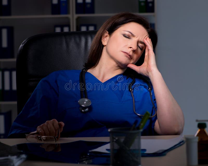 Aged Female Doctor Working at Night Shift Stock Photo - Image of ...