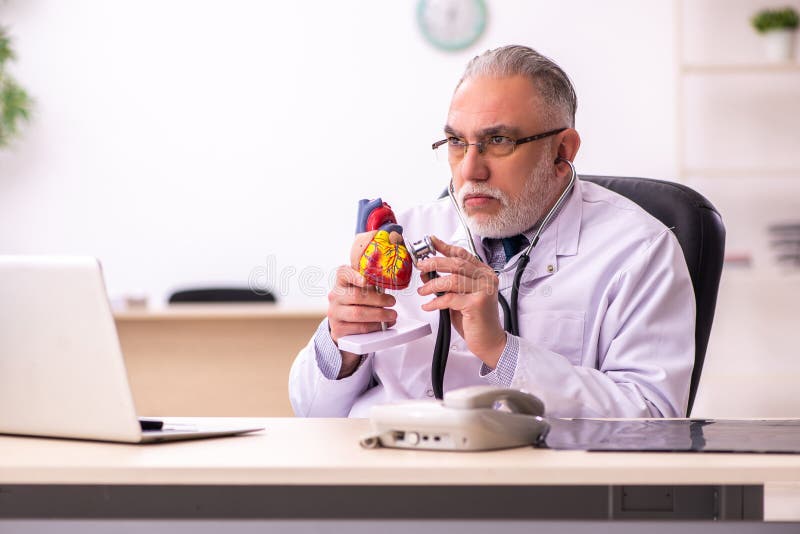 Aged Male Doctor Cardiologist Working in the Clinic Stock Image - Image ...