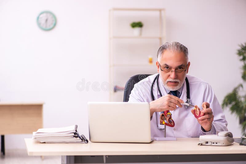 Aged Male Doctor Cardiologist Working in the Clinic Stock Image - Image ...