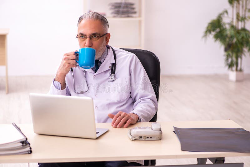 Aged Male Doctor Drinking Coffee in the Clinic Stock Photo - Image of ...