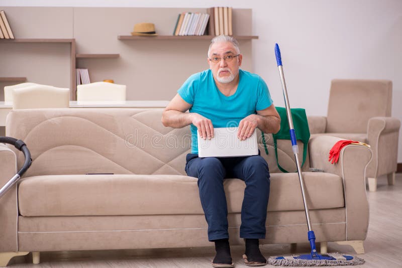 Old man cleaning the house stock photo. Image of service - 222583898