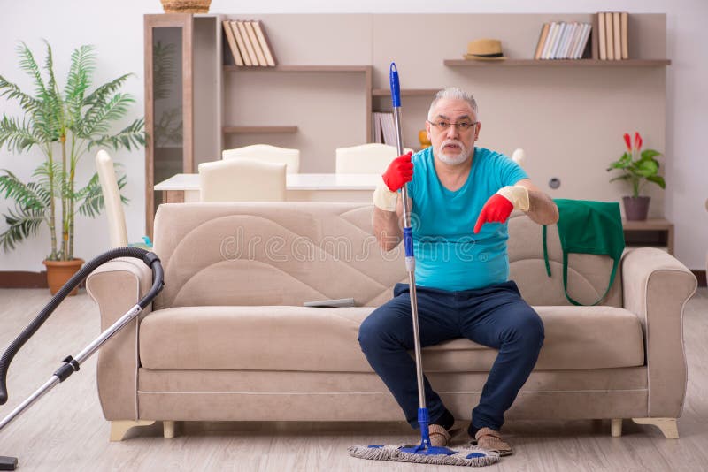 Old man cleaning the house stock photo. Image of maid - 223423892