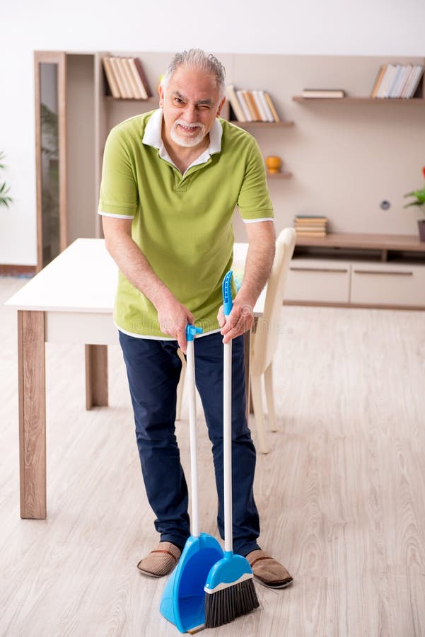 Old man cleaning the house stock image. Image of washing - 228091263
