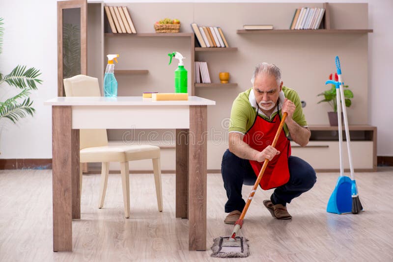 Old man cleaning the house stock photo. Image of home - 228092578