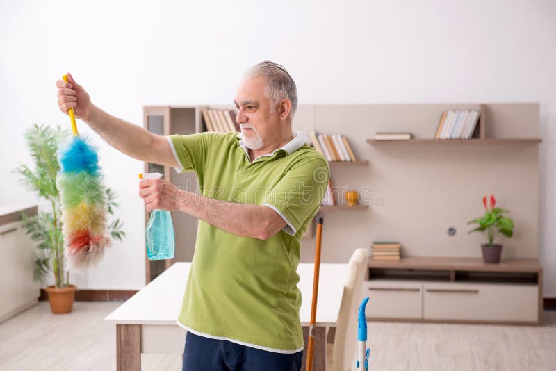 Old man cleaning the house stock photo. Image of dirty - 235724402