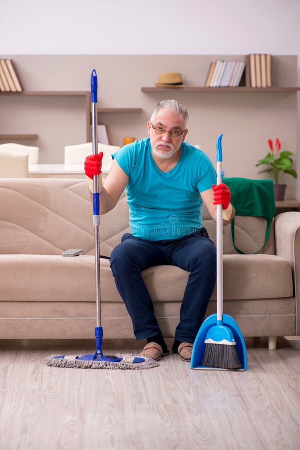 Old man cleaning the house stock photo. Image of maid - 229652128