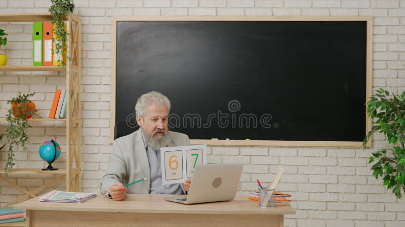 Aged Man College Professor Sit at Desk in Classroom in Front of ...