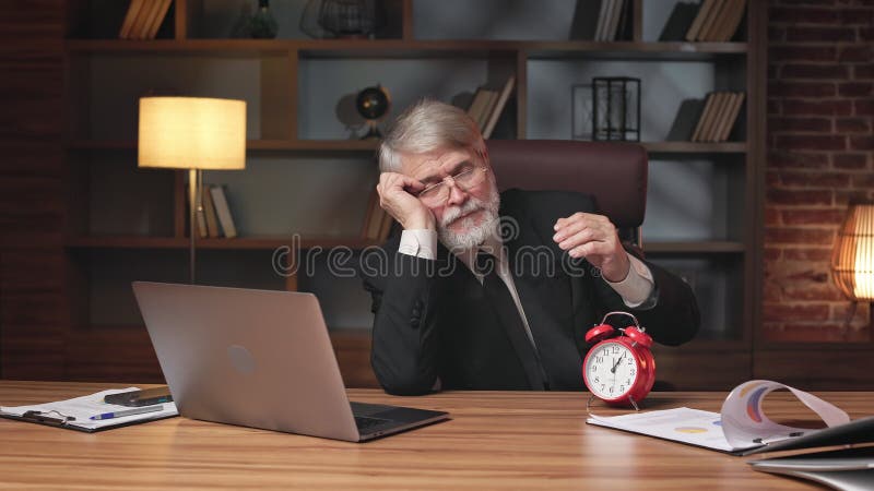 Aged Man Falling Asleep at Office Desk with Alarm Clock Stock Video ...