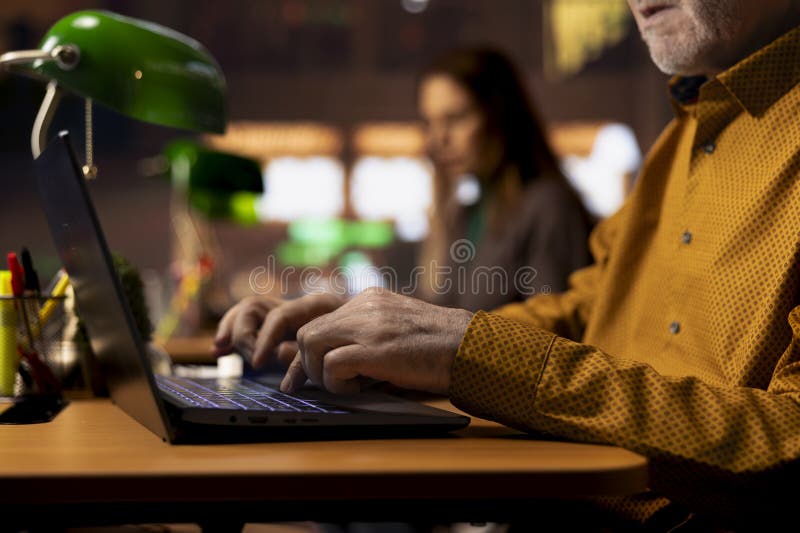 Aged Man in a Public Library Preparing Thesis Paperwork Under a Green ...