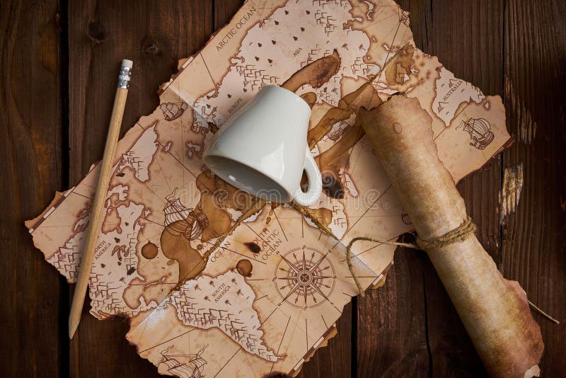 Aged Parchment Scroll with an Old Map and a Spilled Coffee Cup on a ...