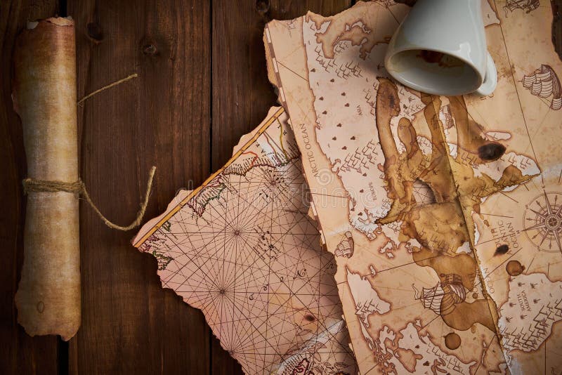 Aged Parchment Scroll with Old Maps and a Spilled Coffee Cup on a ...