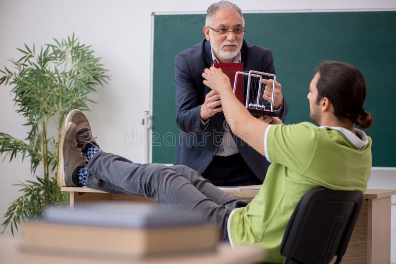 Aged Physics Teacher and Male Student in the Classroom Stock Image ...