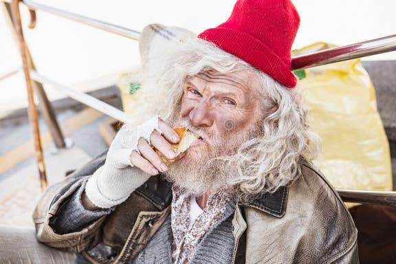 Aged poor man eating stock image. Image of population - 117698939