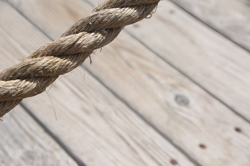 Aged Rope with Wooden Floor Boards in the Background Creating a Natural ...