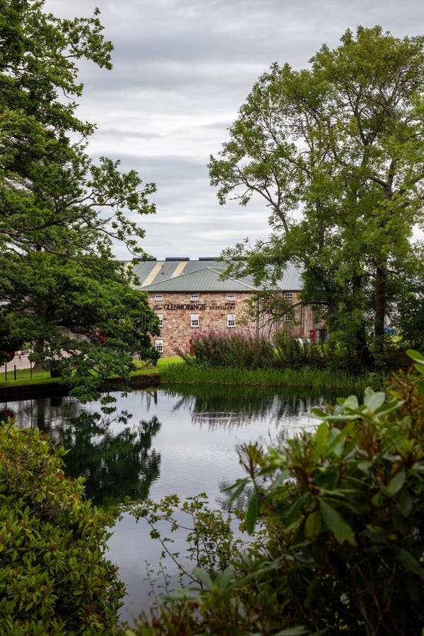 Aged Stone Structure Situated in Front of a Large Tranquil Pond with a ...