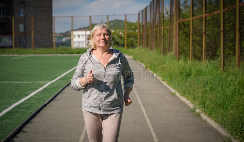 Aged woman jogging. stock image. Image of adult, jogging - 152109907