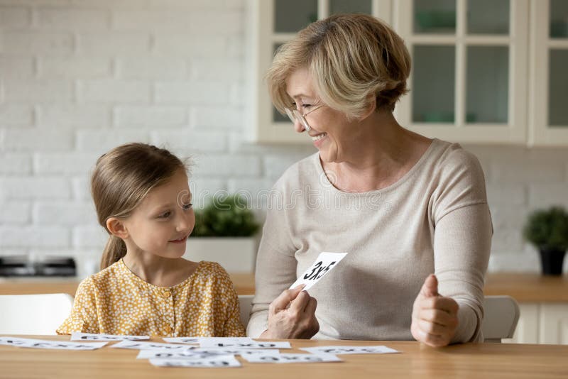 Aged Woman Teacher Study Math with Pupil Girl Using Cards Stock Image ...