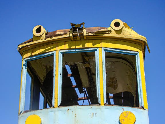 An Aged Yellow-blue Tram Car with Rounded Corners and Rust, Under a ...