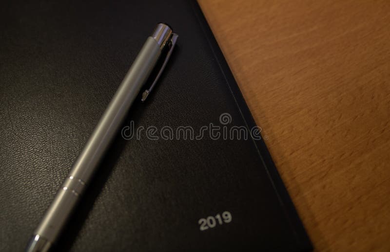Agenda and Pen Laying on a Desk Stock Photo - Image of wood, collection ...