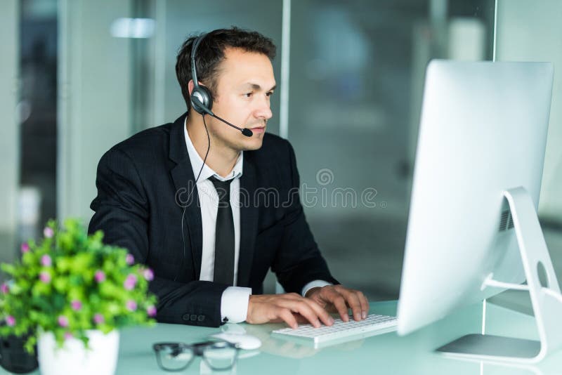 Agent with Headset Smiling while Working on His Computer Stock Photo ...