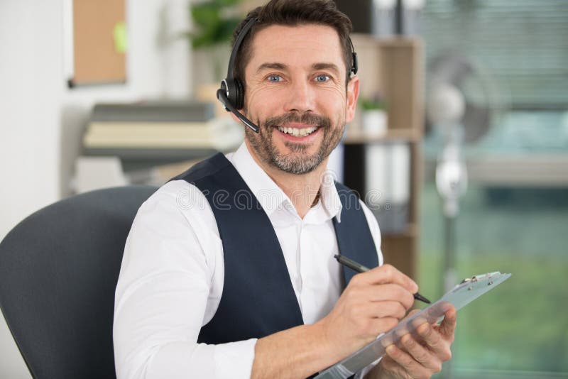 Agent Taking Notes while Talking with Customer Using Headset Stock ...