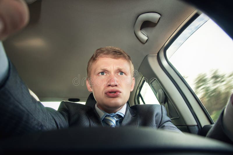 Angry Driver Behind the Wheel of a Car while Driving Stock Image ...