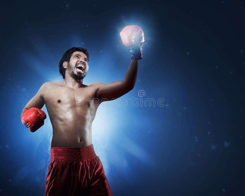 Aggressive Asian Man Boxer with Gloves Training Throwing Punch Stock ...