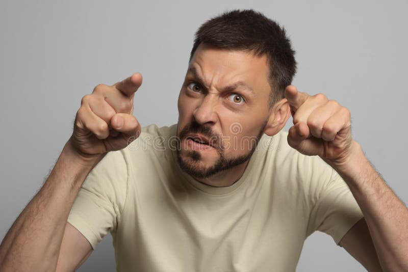 Aggressive Man Pointing on Orange Background. Hate Concept Stock Photo ...