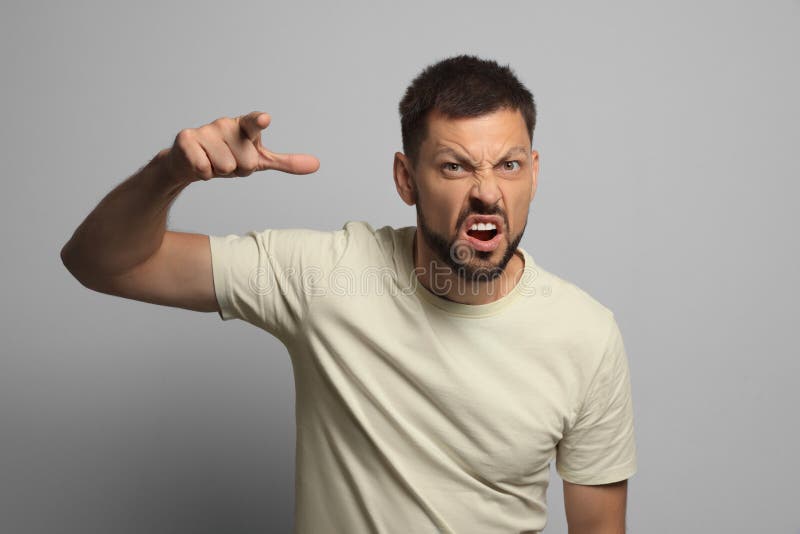 Aggressive Man Pointing on Grey Background. Hate Concept Stock Image ...