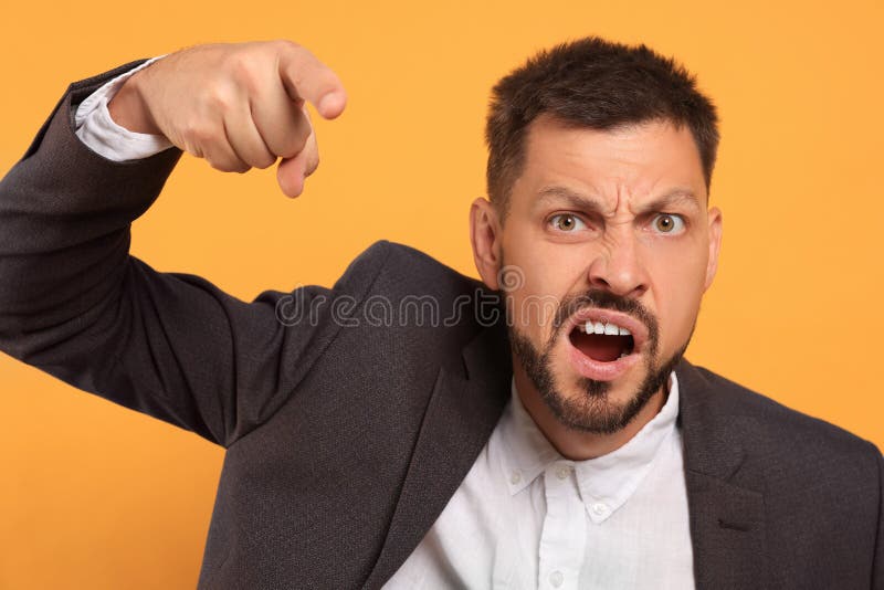 Aggressive Man Pointing on Orange Background. Hate Concept Stock Image ...