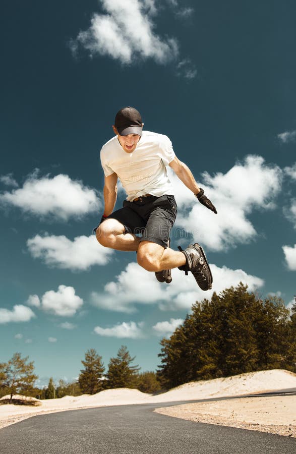 Aggressive Skating. a Young Athlete Performs a Roller Skate Jump. Stock ...