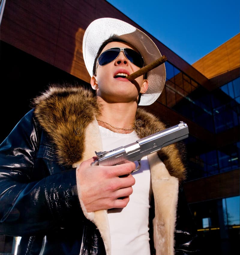 Aggressive Young Gangster with a Gun and Cigar Stock Image - Image of ...