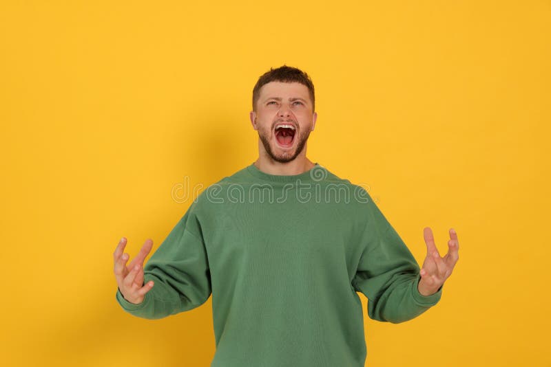 Aggressive Young Man Shouting on Orange Background Stock Image - Image ...
