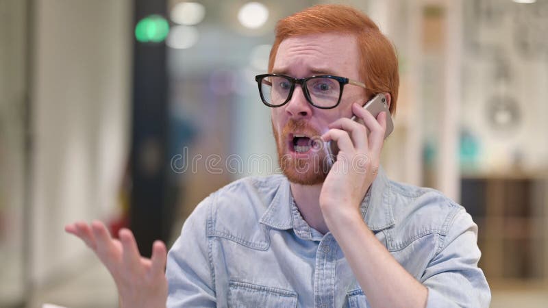 Cheerful Young Redhead Man Talking on Phone, Negotiation in Office ...